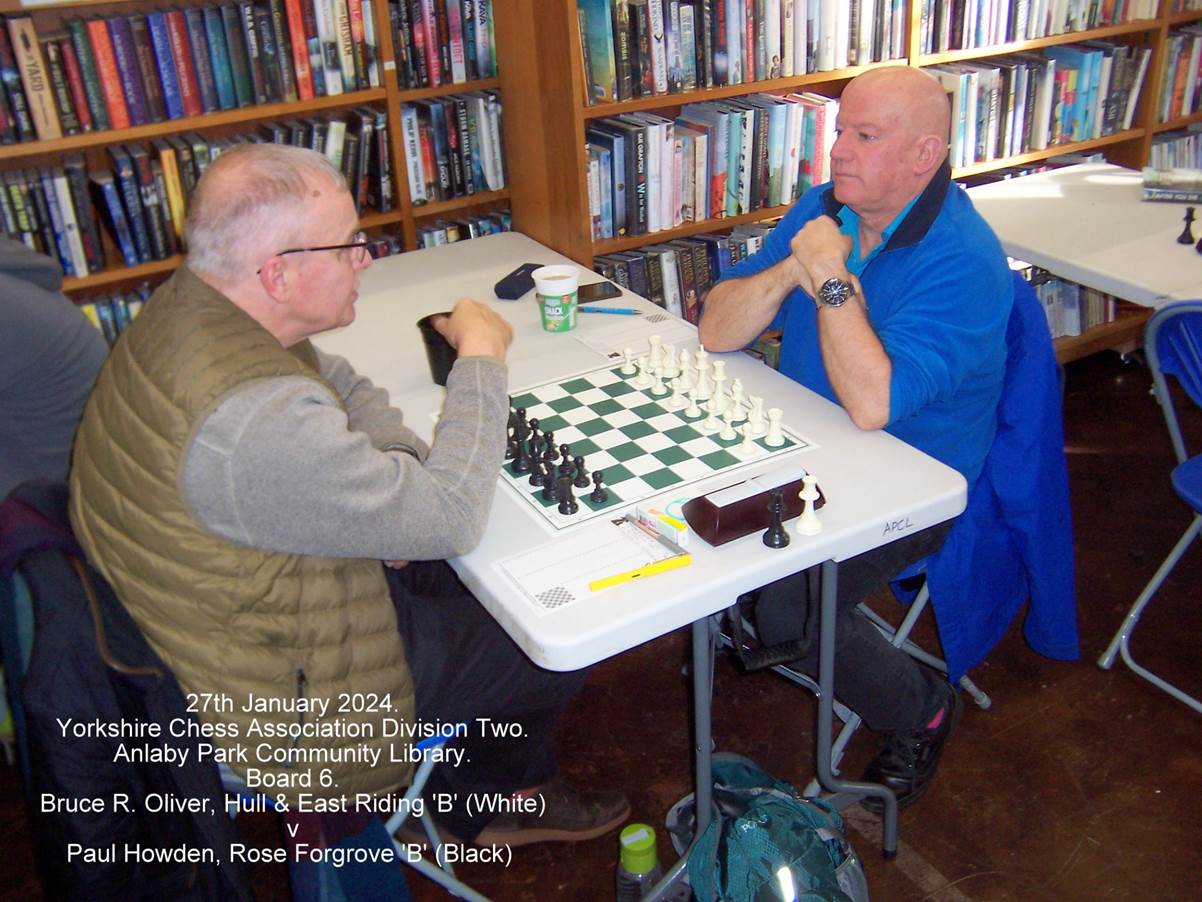 Two men playing chess in a libraryDescription automatically generated